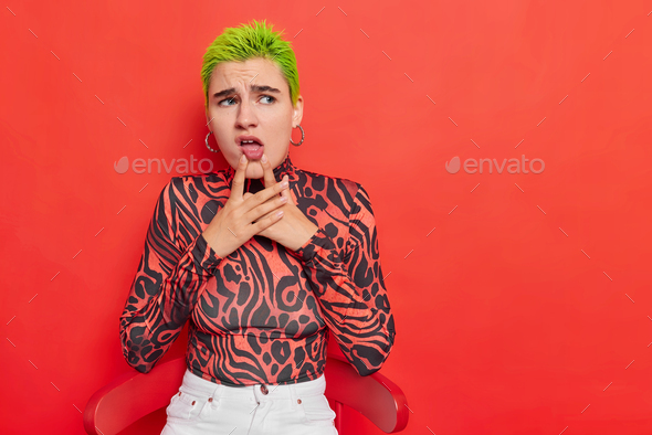 Horizontal shot of puzzled displeased woman frowns face has bothered ...