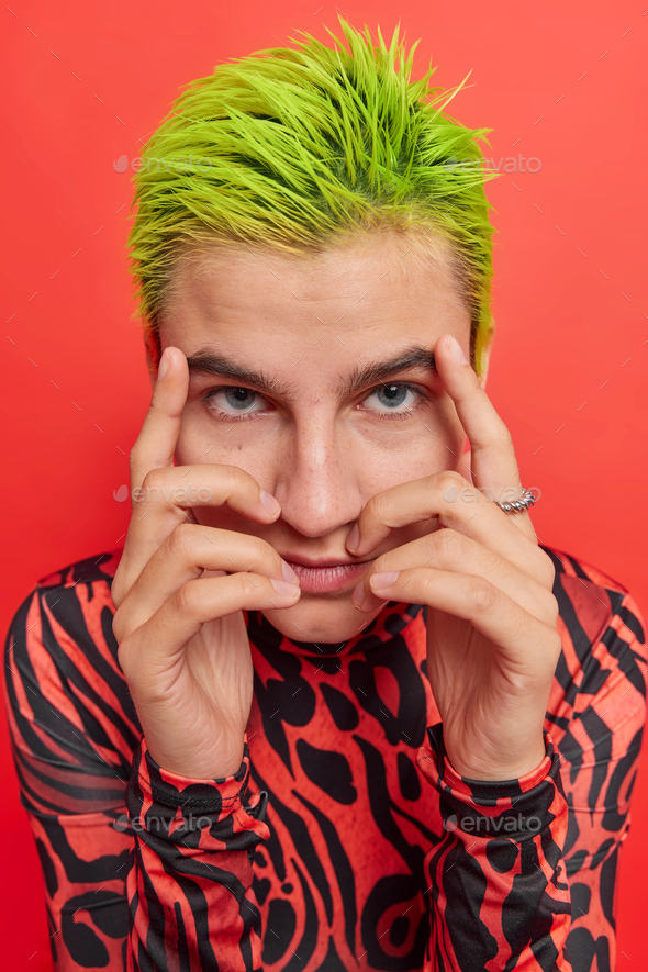 Serious emo girl keeps fingers on temples tries to focus on serious question wears casual ...