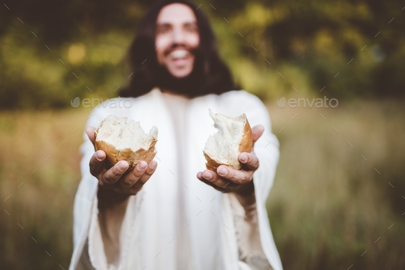 Shallow focus shot of Jesus Christ giving out a sliced breads Stock ...