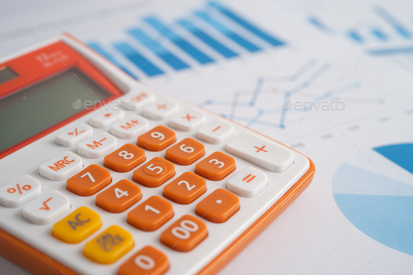 Calculator on chart and graph paper. Finance development, Banking ...