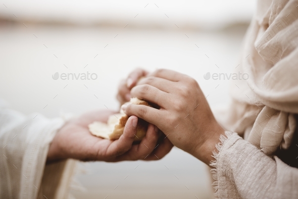 Biblical scene - of Jesus Christ handing out bread wit ha blurred ...