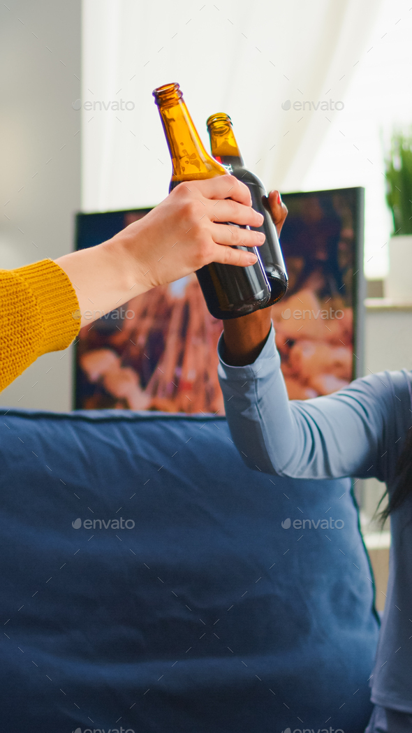 Multiracial friends with masks enjoying a beer during new normal party ...