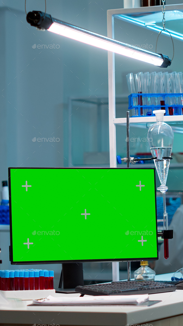 Chemists working in background of lab using pc with green screen Stock ...
