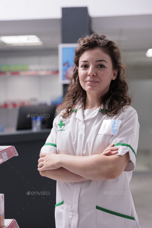Pharmacy worker in medical uniform standing with arm crossed Stock ...