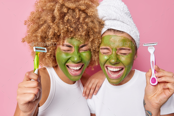 Overjoyed young female models hold razors for shaving undergo hygiene ...