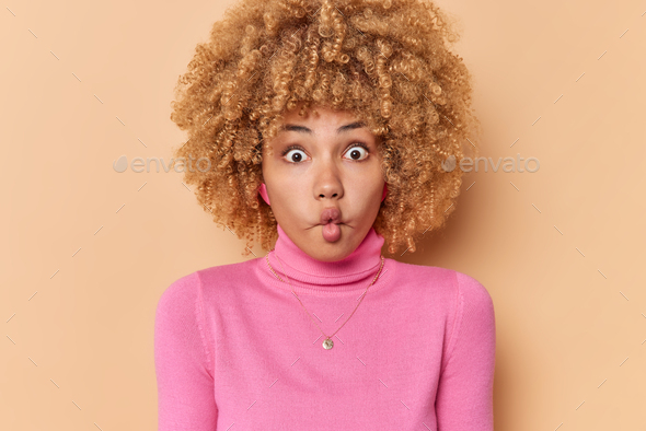 Silly funny curly haired blonde young woman makes fish lips foldsmouth ...