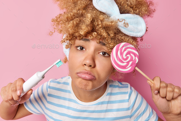 Dissatisfied woman has problems with teeth as eats many sweets suffers ...
