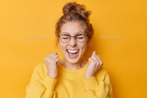 Hopeful cheerful overjoyed woman with combed hair celebrates victory ...