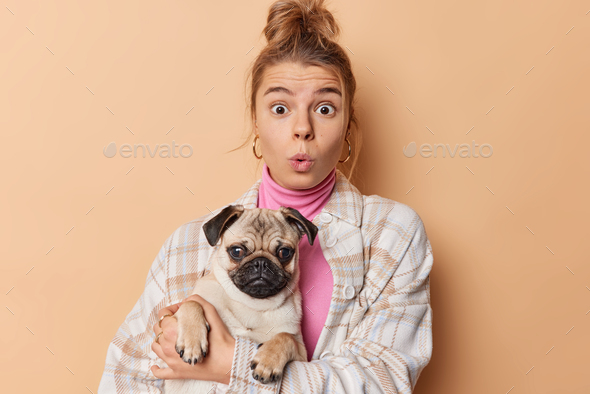 Stunned European woman stares with shocked expression impressed to hear ...