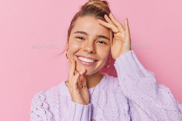 Portrait of happy delighted woman touches face getly has healthy clean ...