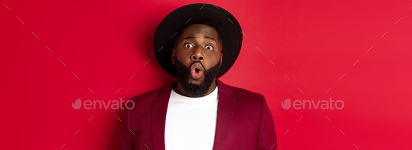 Close-up of surprised Black man staring at camera with wonder, standing ...