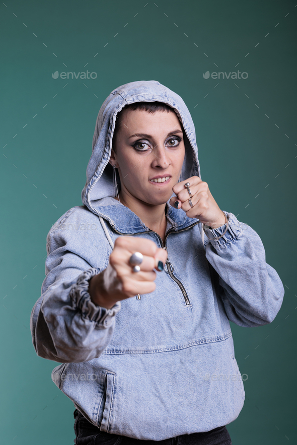 Angry woman boxer with hood on standing in self defense pose Stock ...