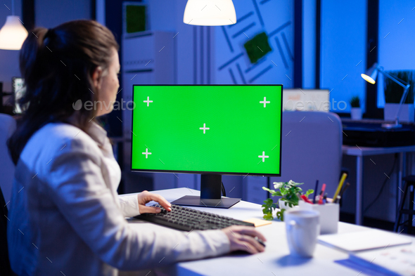 Businesswoman looking at green screen monitor of computer Stock Photo ...