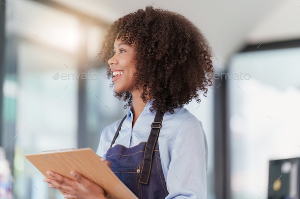 Young Female manager in restaurant with notebook. Woman coffee shop ...