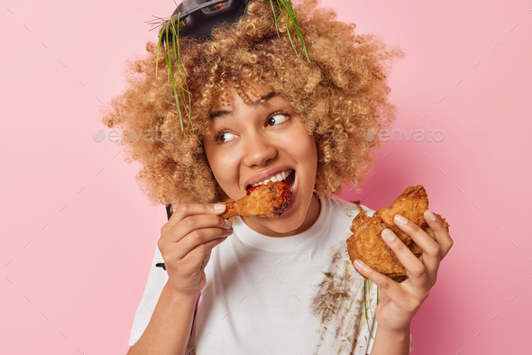 Beautiful woman feels very hungry eats chicken nuggets with ketchup ...