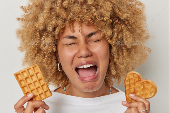 Headshot of doleful crying young woman with curly hair hold homemade ...