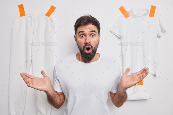 Shocked unaware man spreads palms cannot decide what to do looks ...