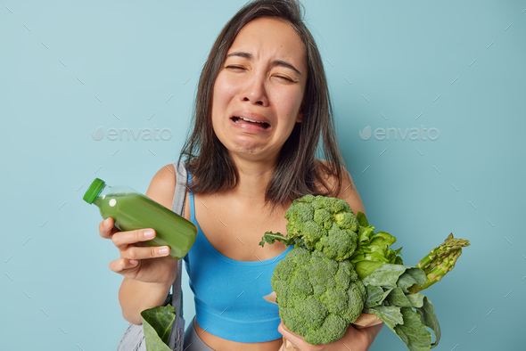 Healthy drink antioxidant and nutriton concept. Upset crying young ...