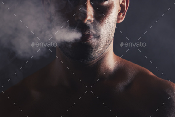 Smoke cloud, face and man in studio for addiction, smoker and bad habit ...