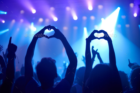 Showing their love. Shot of adoring fans at a rock concert. Stock Photo ...