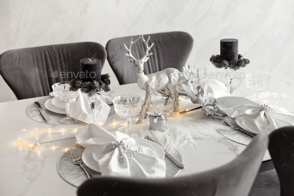 Festive monochrome table setting in gray and silver colors for winter ...