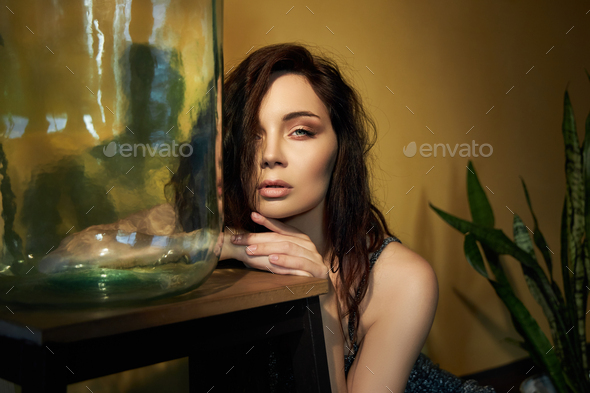 Art Portrait of a makeup woman with reflection of sunlight on her face ...