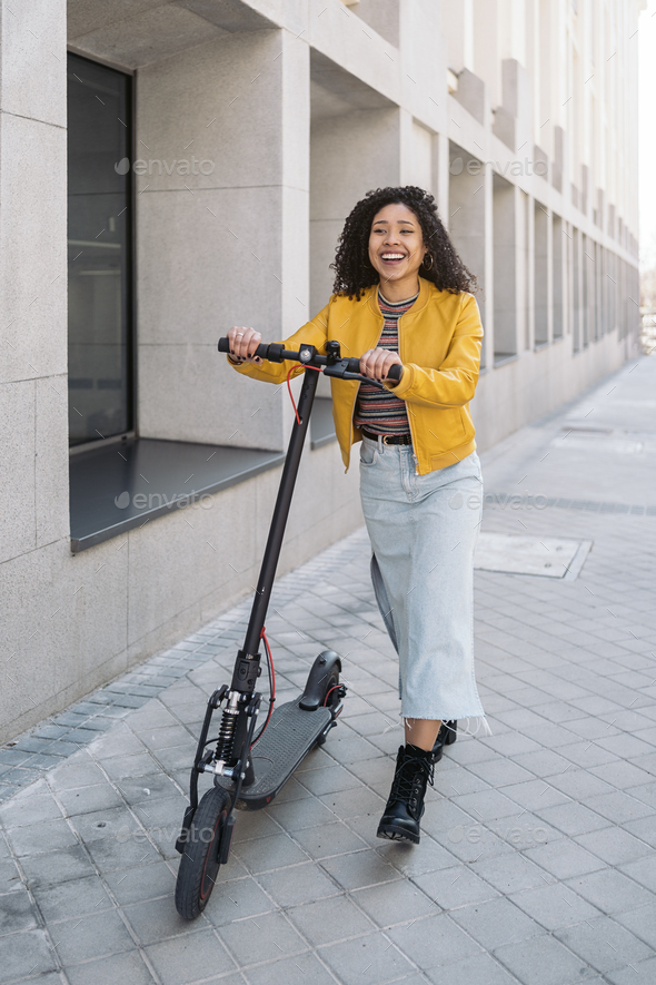 Curly Hair Girl Using Electric Scooter Stock Photo by nunezimage ...