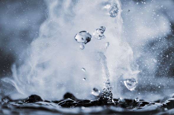 Boiling water splash with steam on black background closeup Stock Photo ...