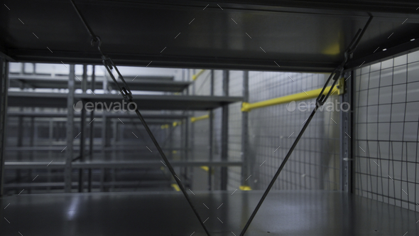 Empty iron shelves in warehouse. Creative. Packaged empty shelves in ...