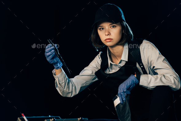 investigator in uniform holding knife and ziploc bag at crime scene ...