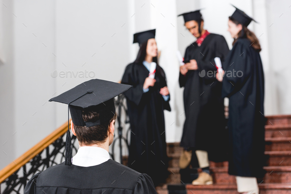 back view of student in graduation cap standing in university Stock ...