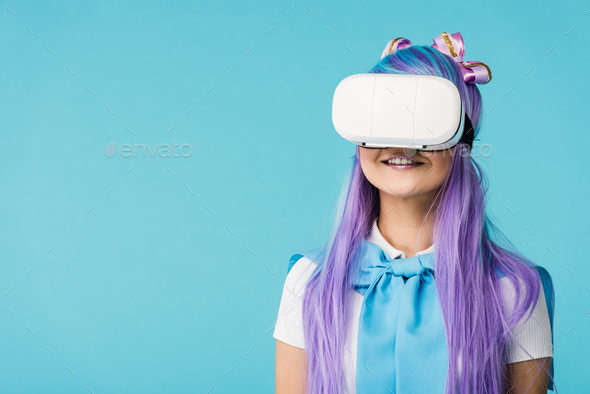 Smiling anime girl in purple wig and vr headset isolated on blue Stock ...