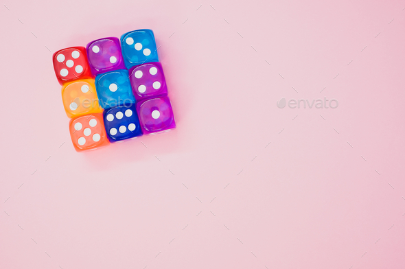 Cube made of colorful dice isolated on a pink background Stock Photo by ...