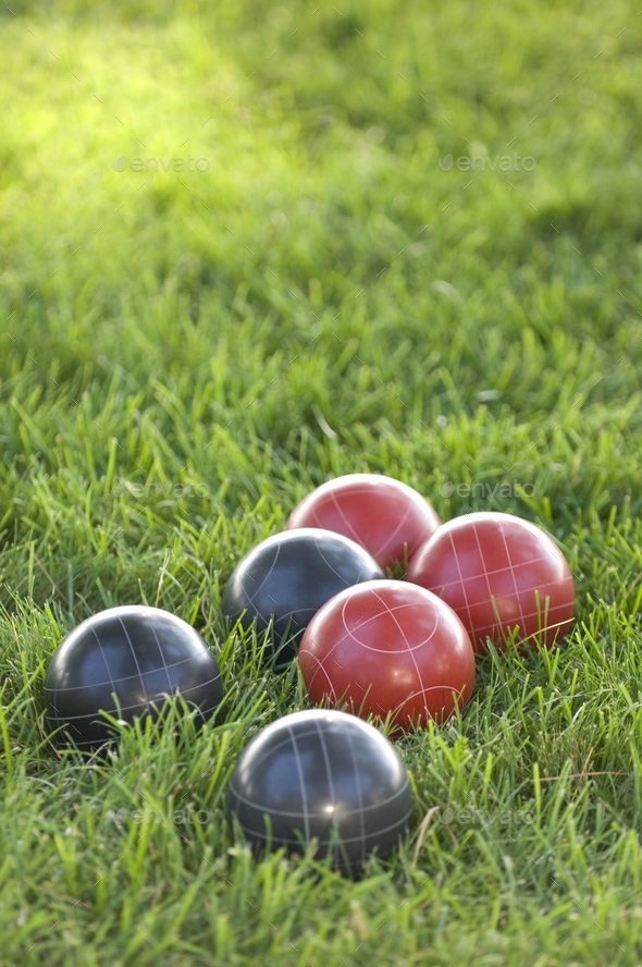 Vertical picture of colourful bocce balls on the lawn under the ...