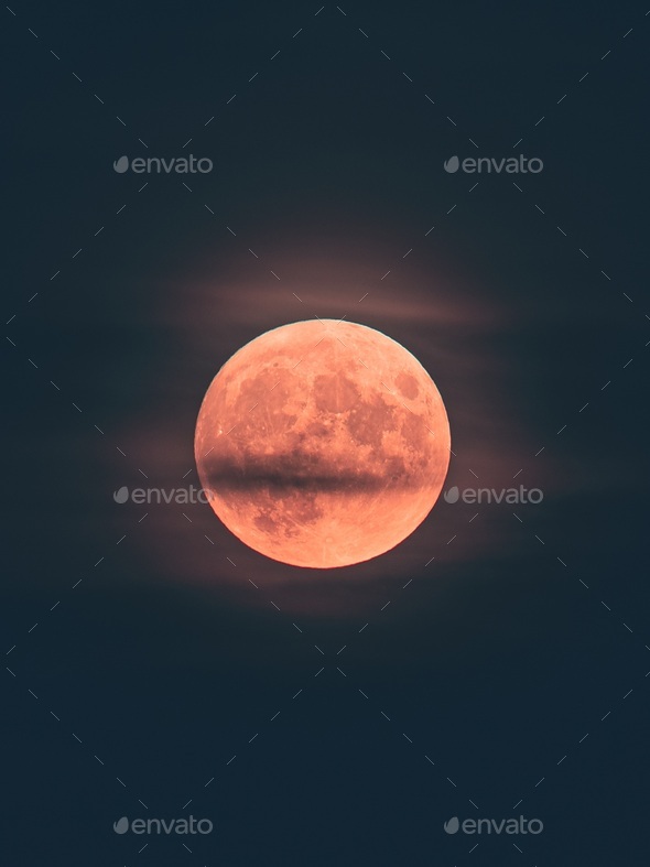 Eerie scenery of the red full moon on a night sky Stock Photo by wirestock