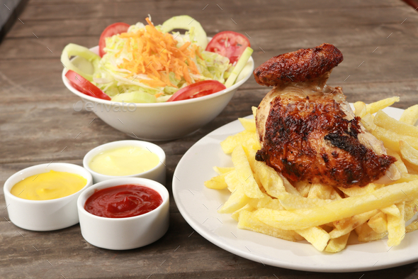 Peruvian food called Pollo a la brasa with salad and french fries Stock ...