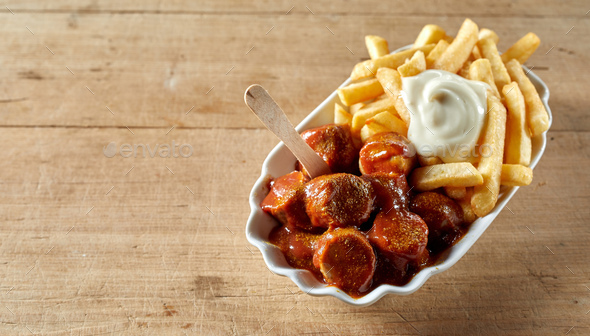 Currywurst with delicious French fries and mayo in bowl Stock Photo by ...