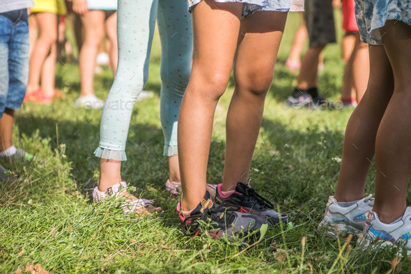Children in a team game. kids together in motion outside and legs of ...