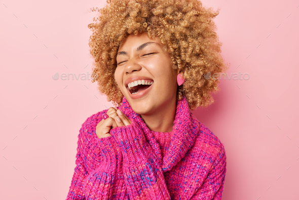 Positive overjoyed woman laughs out loudly keeps hands together has ...