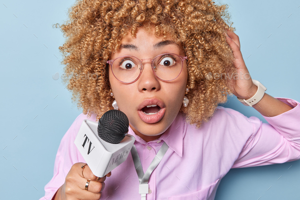 Shocked female journalist holds reporter microphone reports television ...
