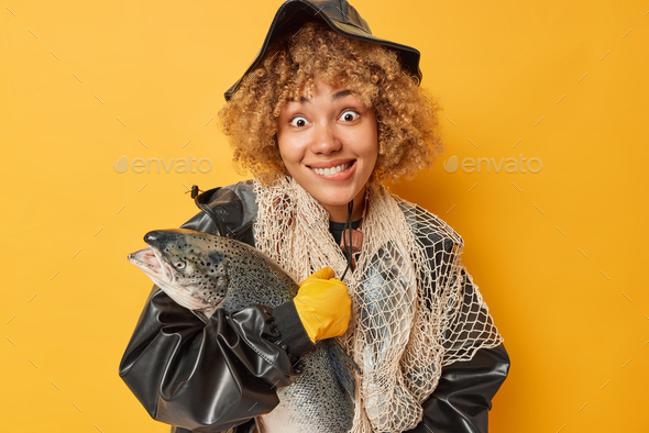 Happy fisherwoman poses with big salmon enjoys successful fishing bites ...