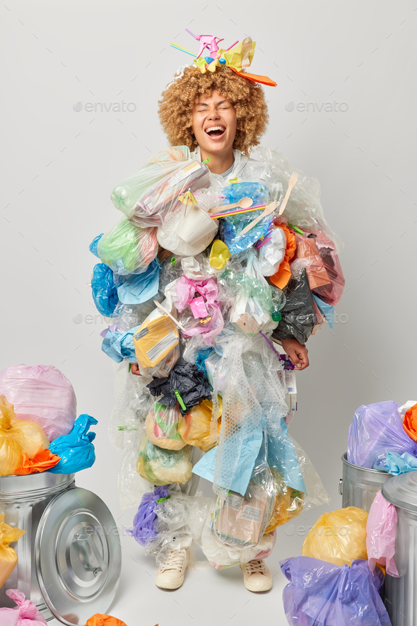 Vertical shot of female volunteer collects plastic garbage cleans up ...