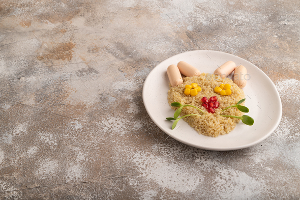 Funny quinoa porridge, and sausages in form of cat face on brown ...