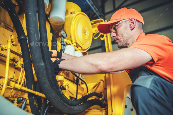 Industrial Heavy Equipment Mechanic at Work Stock Photo by duallogic