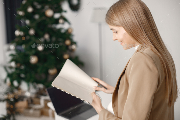 Pregnant lady with papers touching belly sitting on desk in modern ...