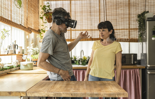 funny married couple in the kitchen are using virtual reality in the ...
