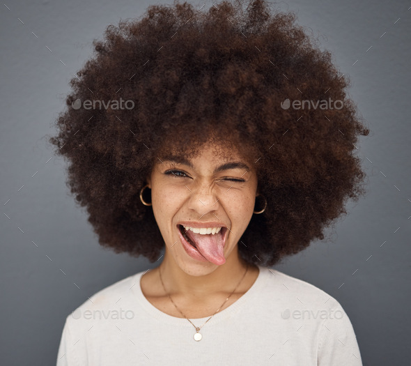 Goofy, face and woman with her tongue out in studio with comic, fun and ...