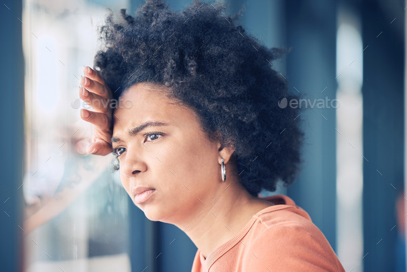Sad, lonely and depressed woman at window waiting, thinking and looking ...