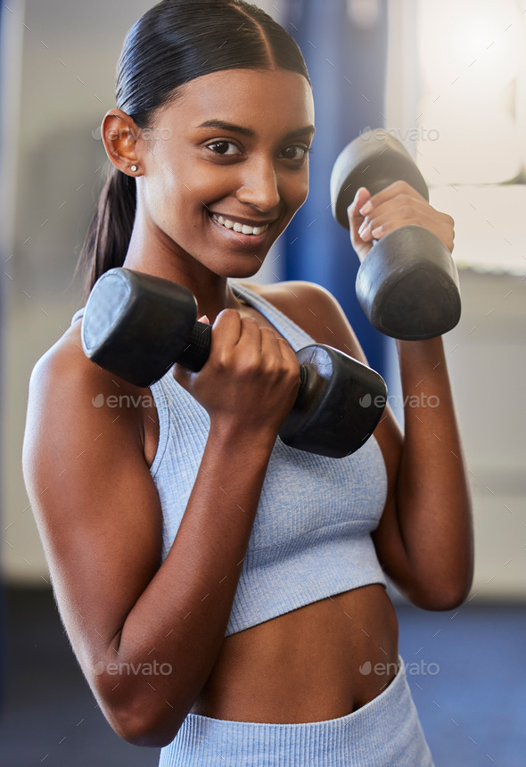 Fitness, Indian woman and dumbbell training portrait in gym for workout ...