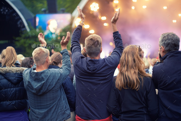 Adoring audience. A crowd dancing at an outdoor music event. Stock ...